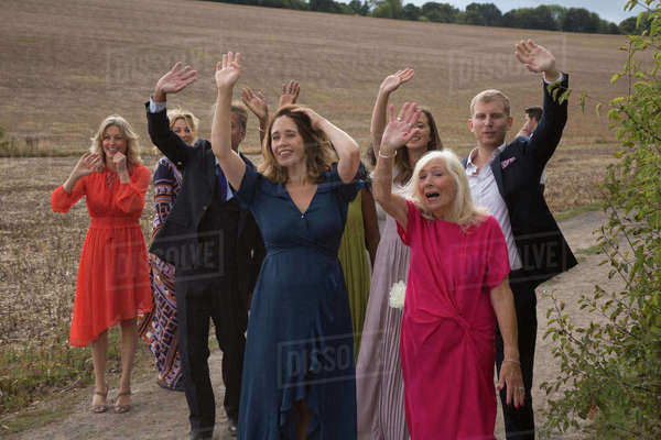 Wedding guests waving off newlyweds - Royalty-free Stock Photo | Dissolve