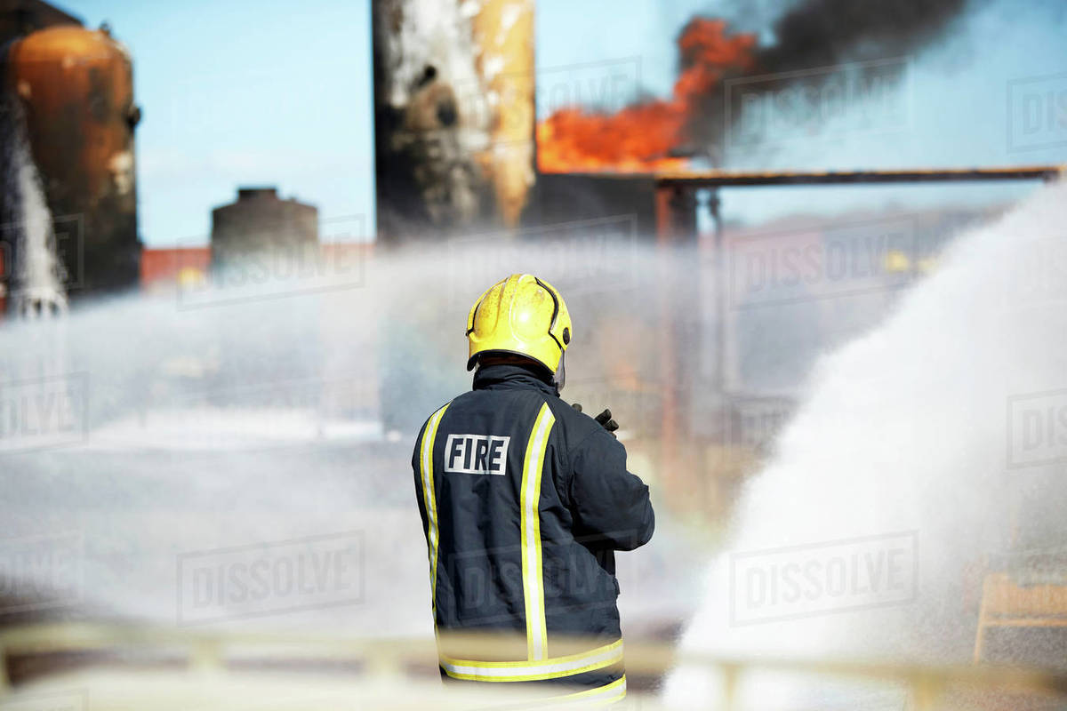 Fireman training to put out fire on burning tanks, Darlington, UK ...