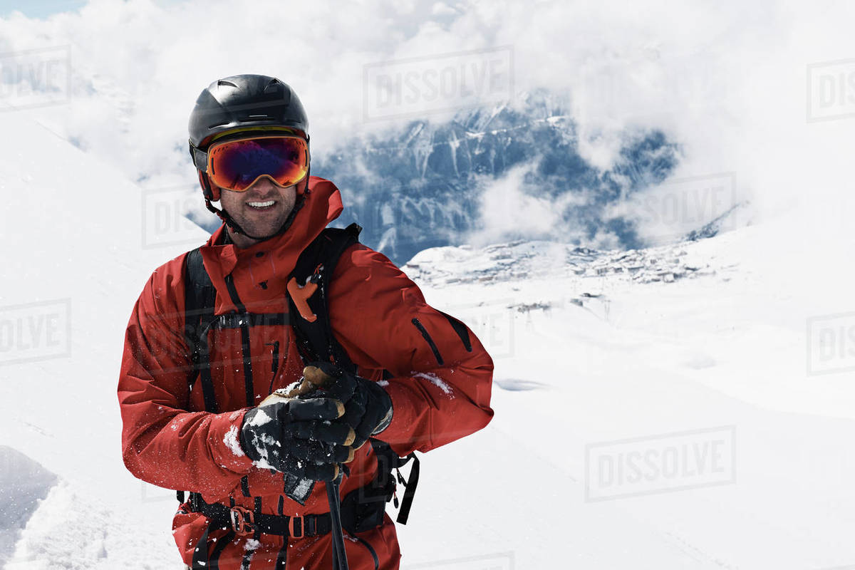Male skier on mountainside, portrait, Alpe-d'Huez, Rhone-Alpes, France ...