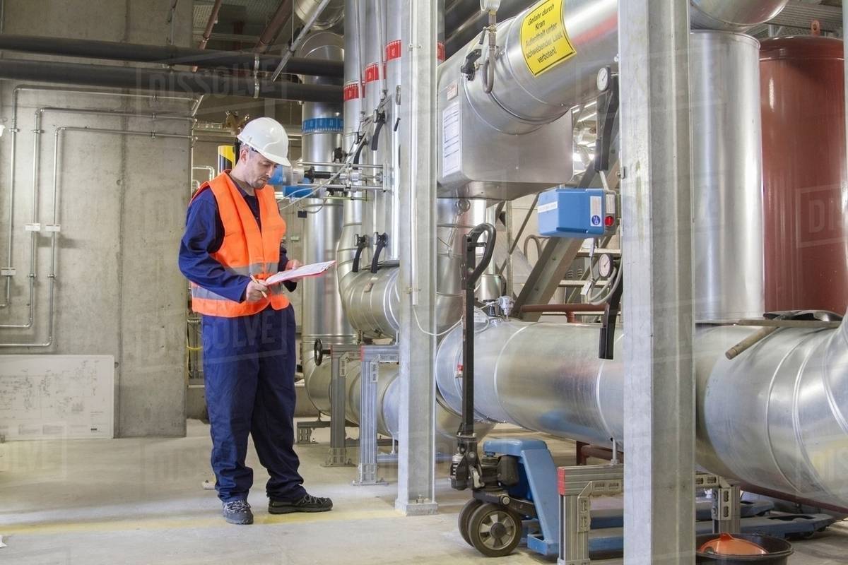 Technician checking paperwork in power station - Royalty-free Stock ...