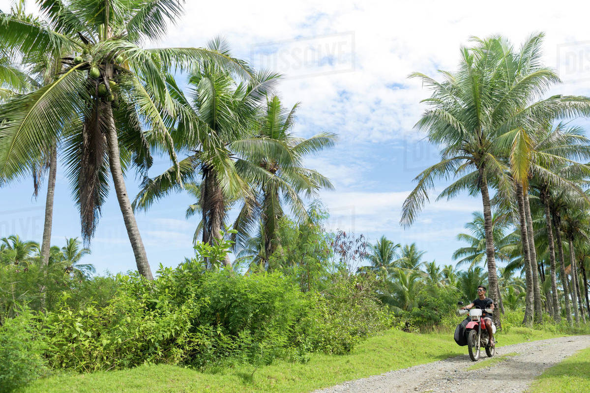 Motorcyclist with surfboard, Abulug, Cagayan, Philippines - Royalty ...