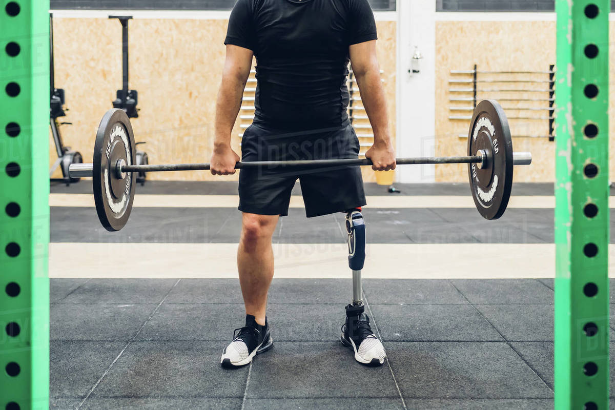Man with prosthetic leg weight training in gym - Royalty-free Stock ...