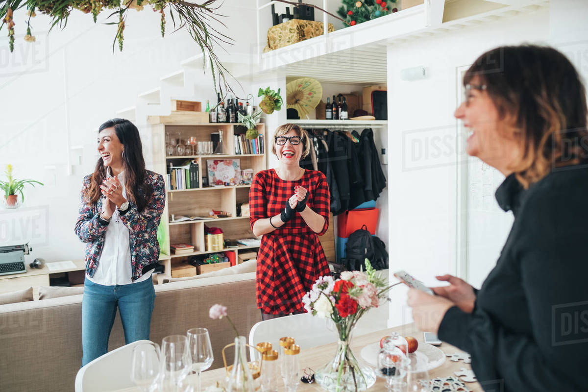 Friends clapping hands at celebration in loft office - Stock Photo ...