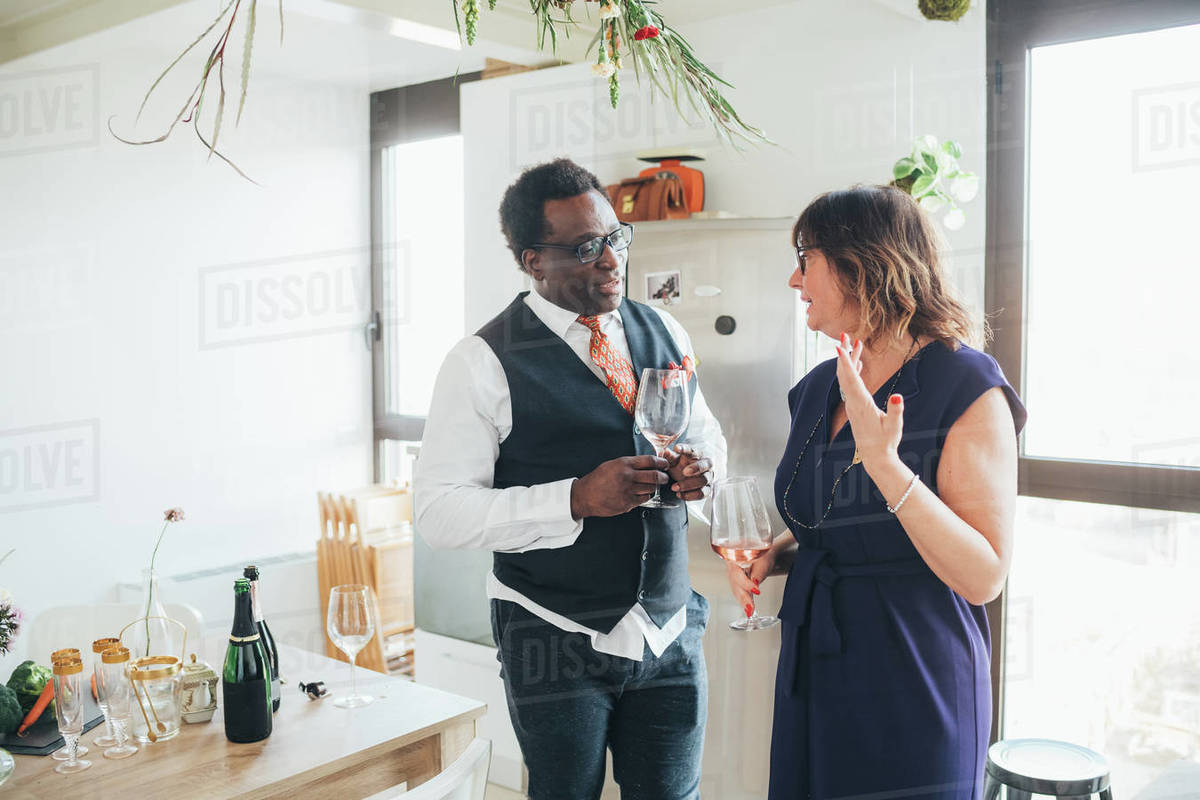 Businessman and businesswoman talking at party - Royalty-free Stock ...