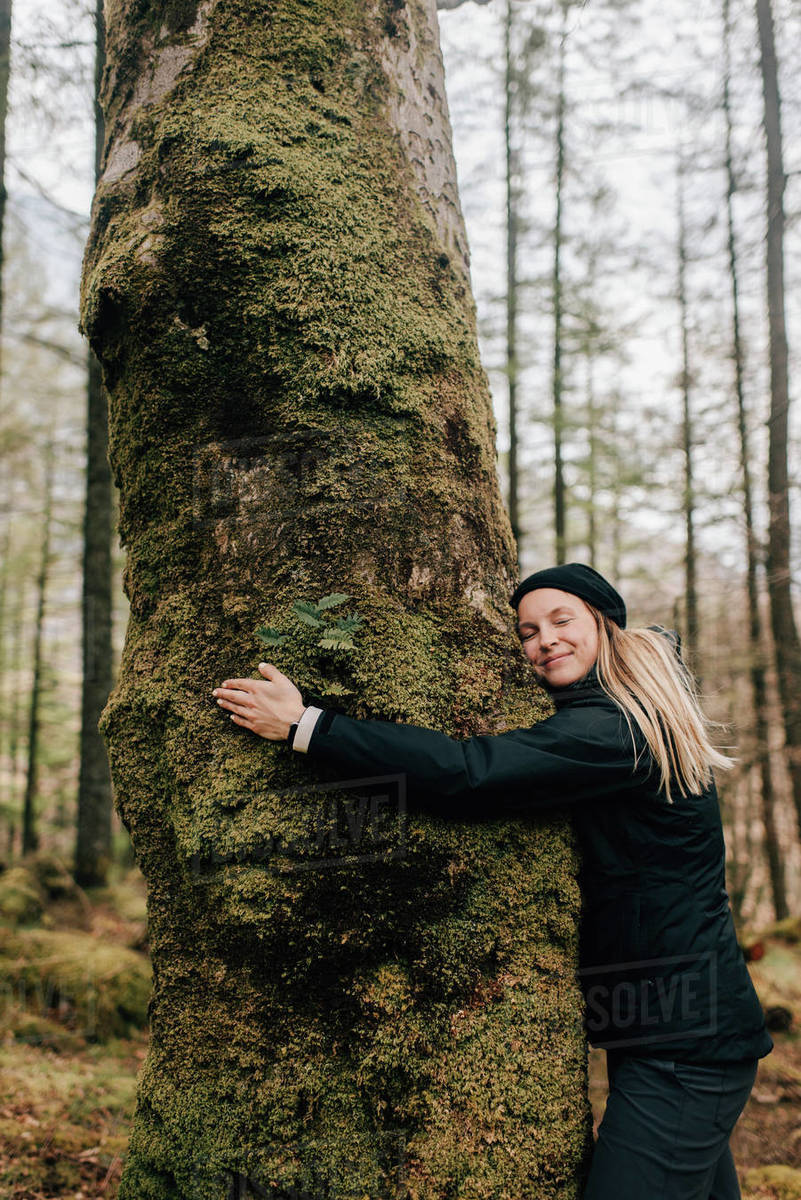 Woman hugging tree, Trossachs National Park, Canada - Royalty-free ...