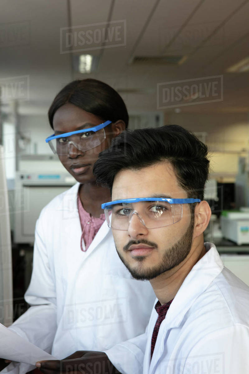 Young female and male scientists in laboratory, portrait - Stock Photo ...