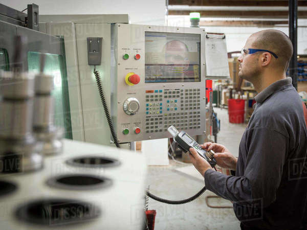 Knife factory worker operating machinery controls - Royalty-free Stock ...