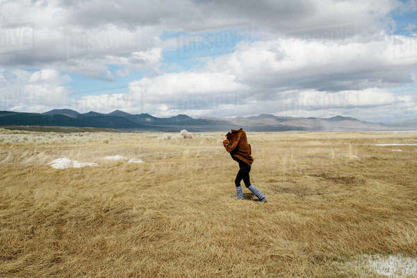 Person walking with jacket over head in countryside, Mammoth ...