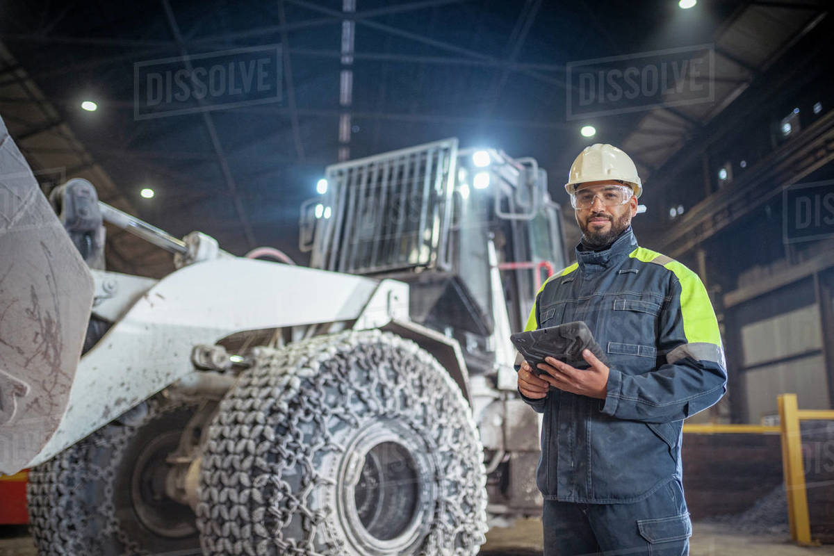 Portrait of steelworker and dumper truck in steelworks - Royalty-free ...
