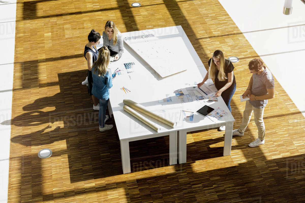 High angle view of group of young architects working on an ...