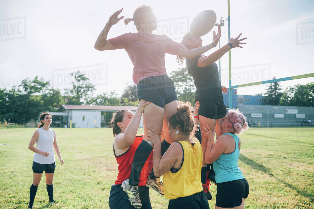 A group of women practicing for rugby lineouts on a training pitch ...