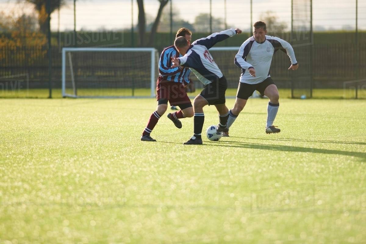 Football players fighting for ball - Royalty-free Stock Photo | Dissolve