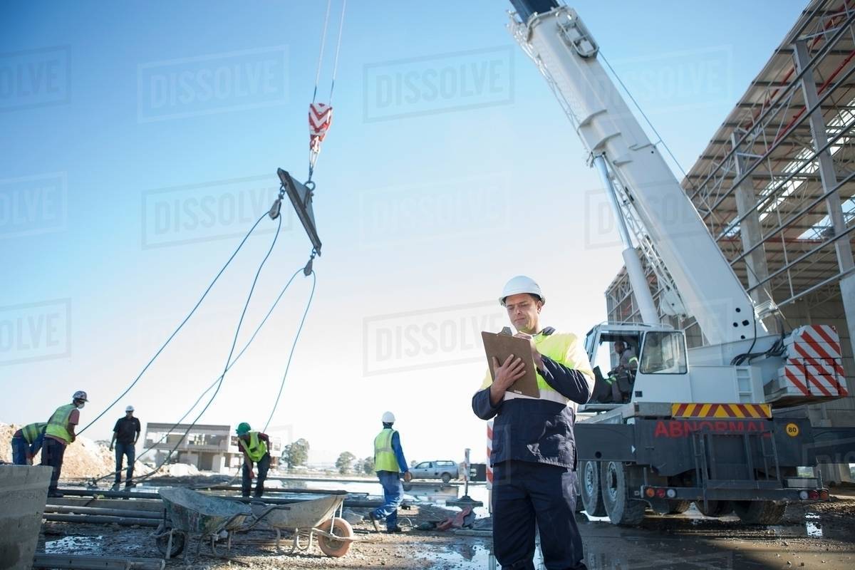 Site manager with clipboard on construction site - Royalty-free Stock ...