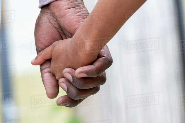 Mixed race mum and son holding hands together. Uncondition love ...