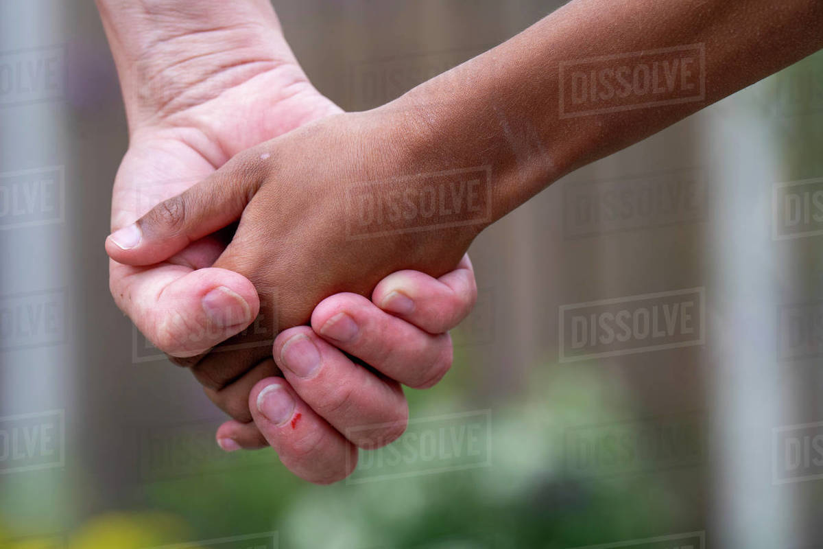 Mixed race mum and son holding hands together. Uncondition love - Stock ...