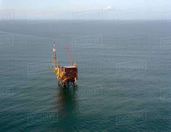 Woman in a bikini enjoys the ocean waves splashing around her on a ...