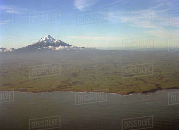 Woman in a bikini enjoys the ocean waves splashing around her on a ...