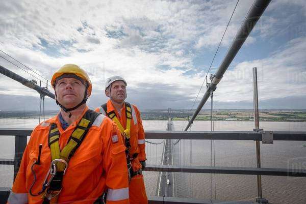 Portrait of bridge workers on top of suspension bridge. The Humber ...