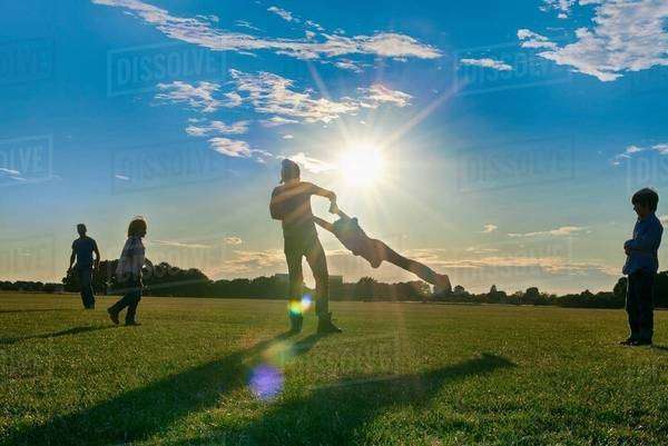 Family enjoying outdoor activities in the park - Royalty-free Stock ...