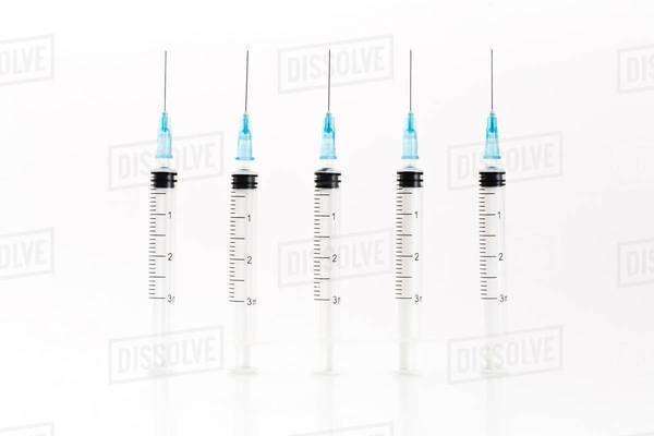 Row of blue syringes - Royalty-free Stock Photo | Dissolve