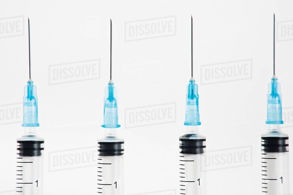 Row of blue syringes - Royalty-free Stock Photo | Dissolve