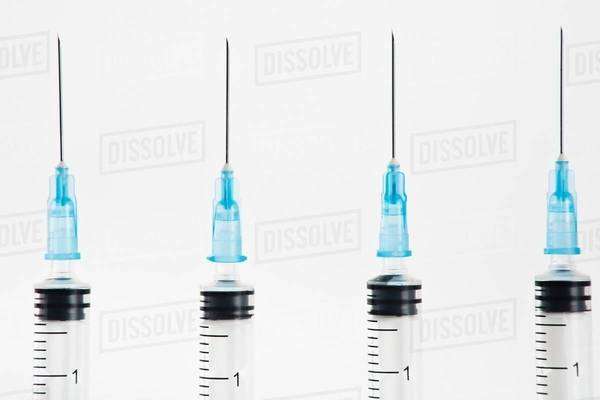 Row of blue syringes - Royalty-free Stock Photo | Dissolve