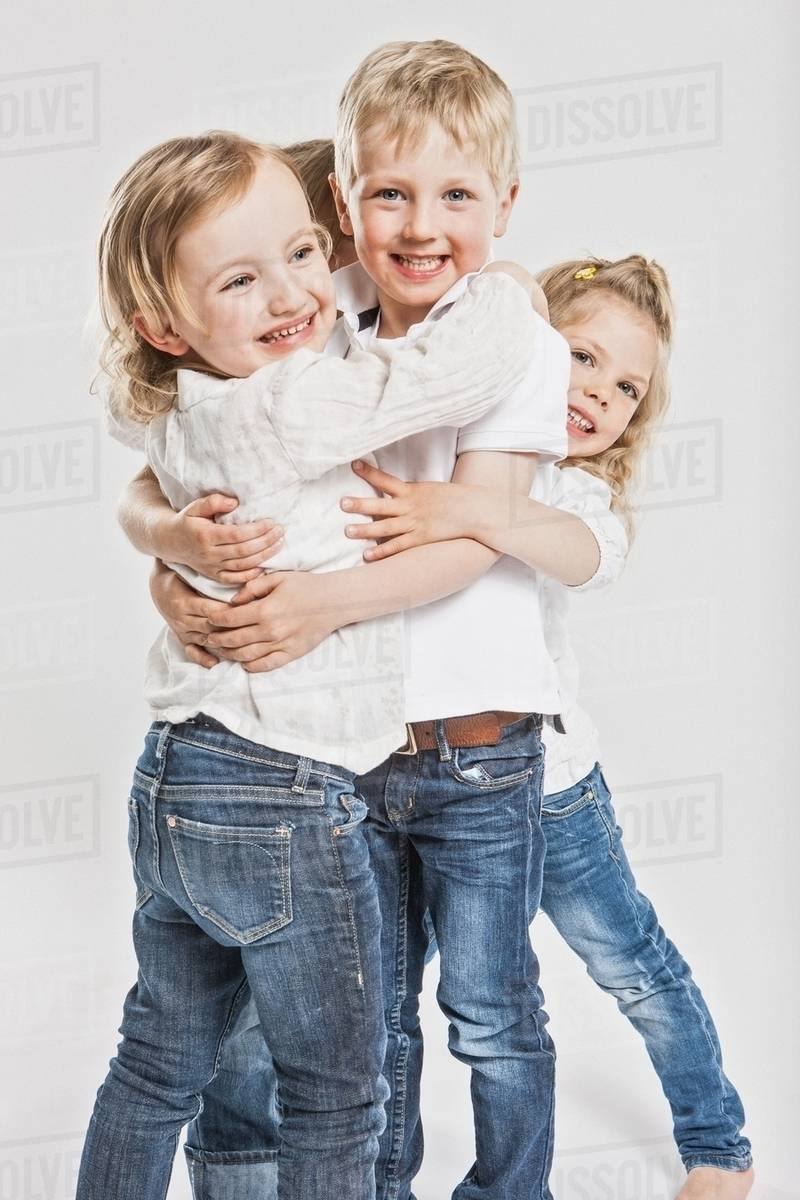 Smiling children hugging - Stock Photo - Dissolve