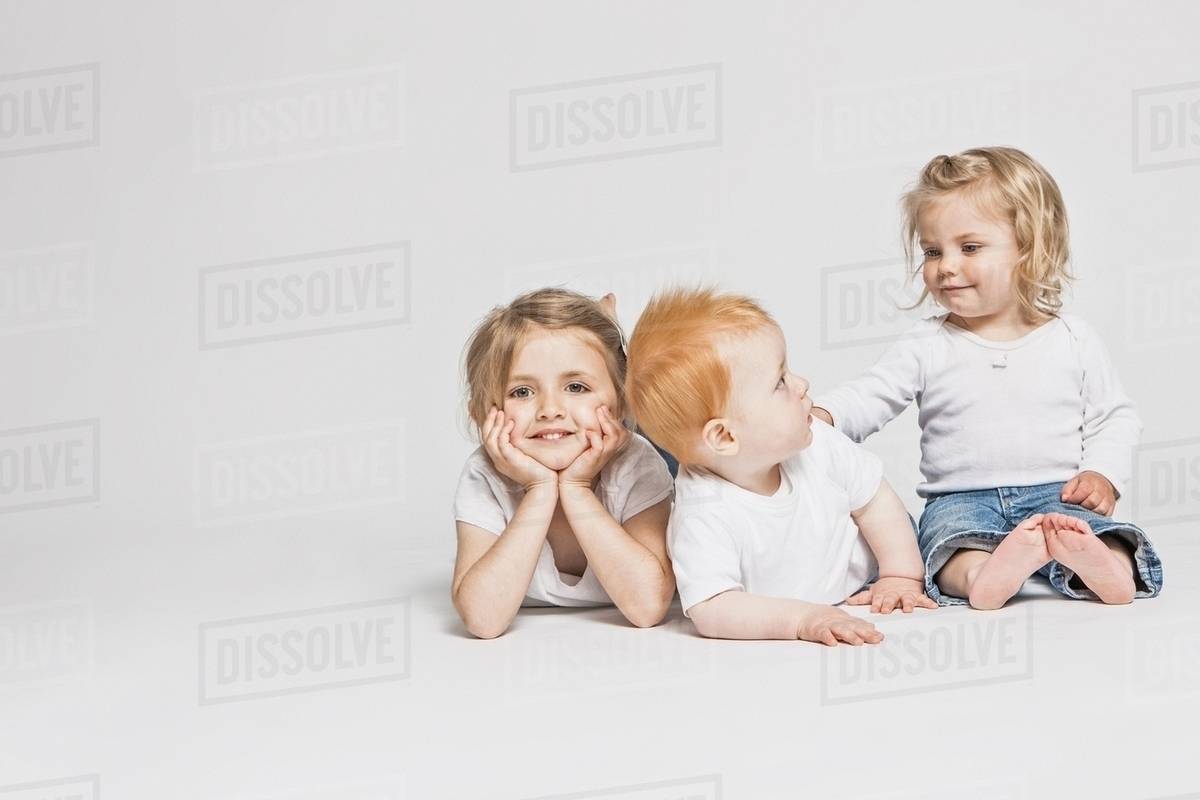 Children sitting together - Stock Photo - Dissolve