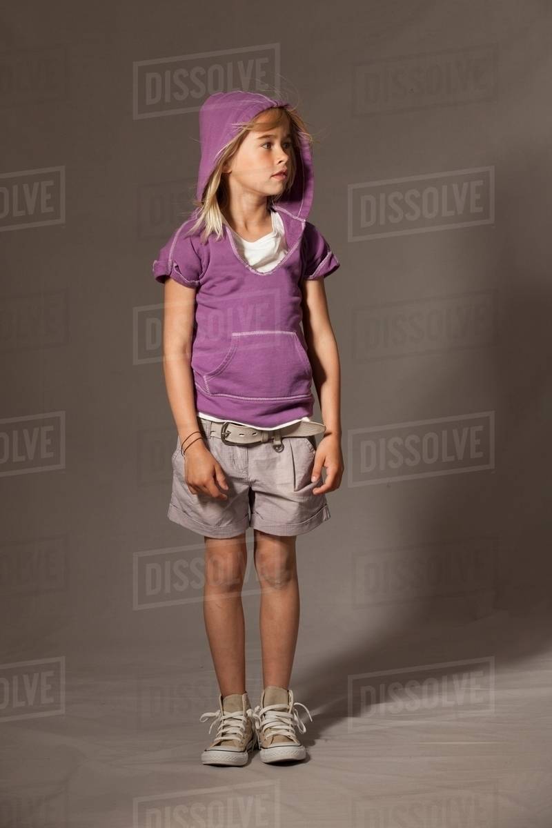 Girl standing in studio - Royalty-free Stock Photo | Dissolve