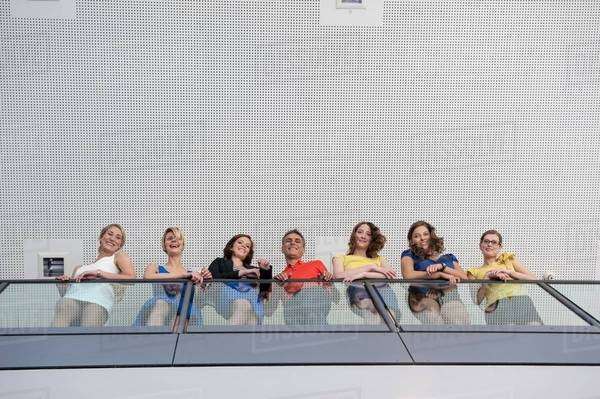 Business people standing on balcony - Stock Photo - Dissolve