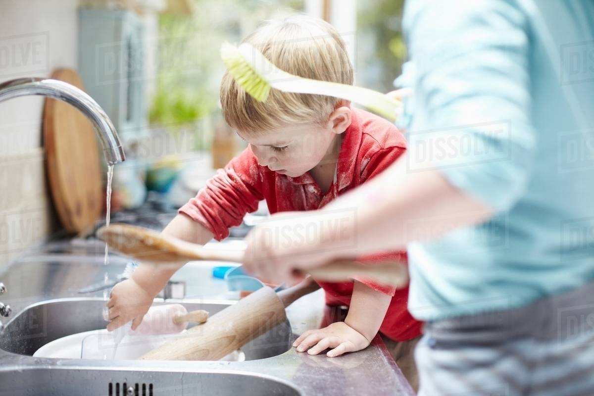 Children washing dishes together - Royalty-free Stock Photo | Dissolve