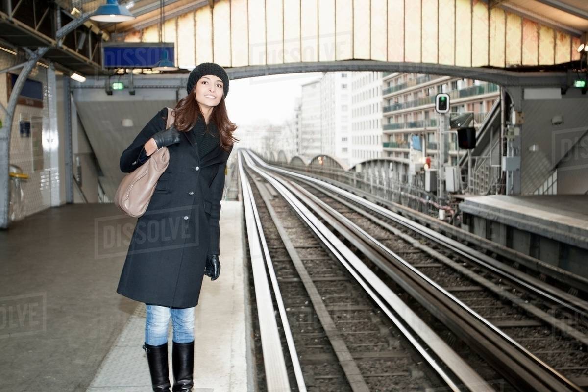 Woman waiting at train station - Royalty-free Stock Photo | Dissolve