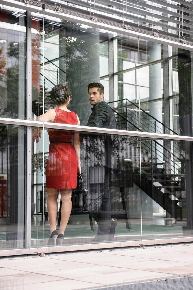 Business people standing by window - Stock Photo - Dissolve