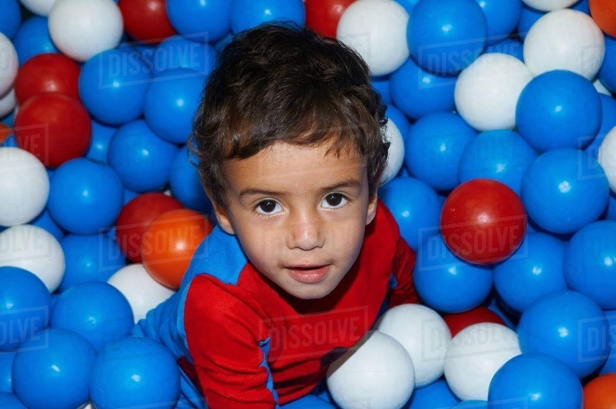 Boy playing in ball pit - Royalty-free Stock Photo | Dissolve