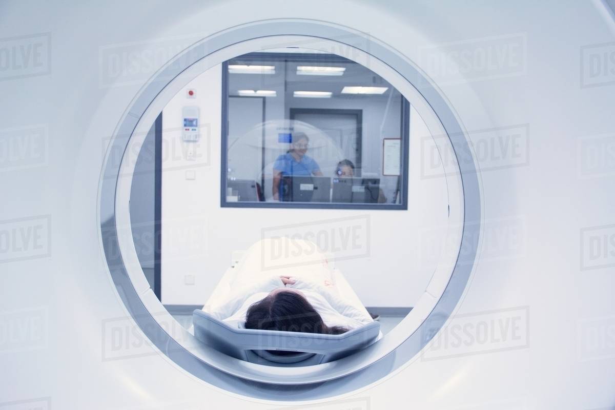 Patient laying in CT scanner - Royalty-free Stock Photo | Dissolve
