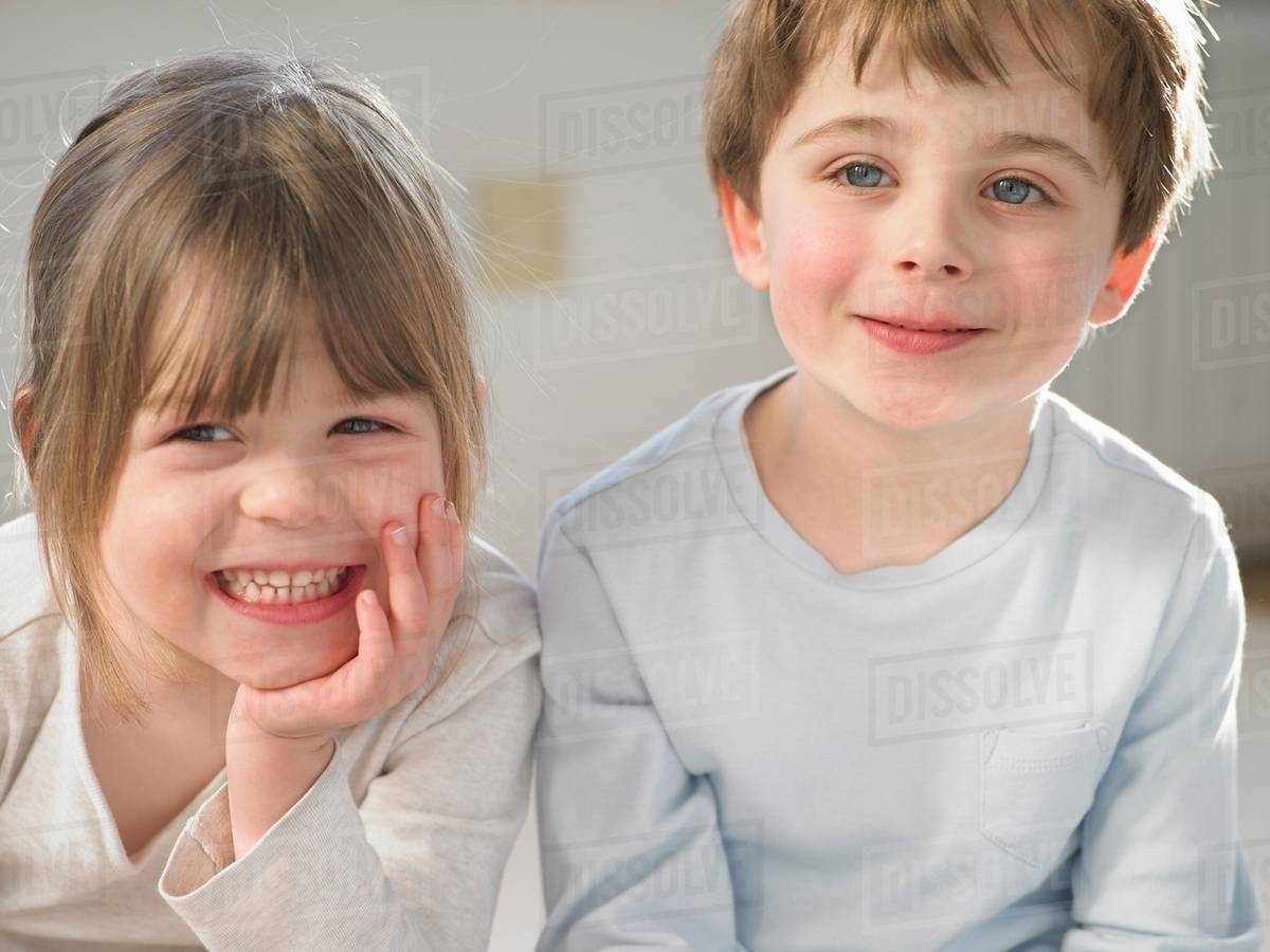 Children smiling together indoors - Royalty-free Stock Photo | Dissolve