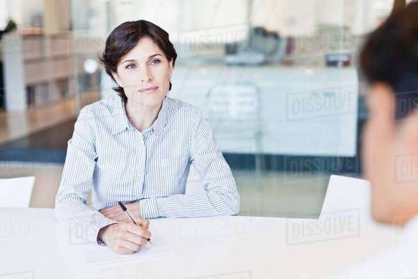 Business people talking at desk - Stock Photo - Dissolve
