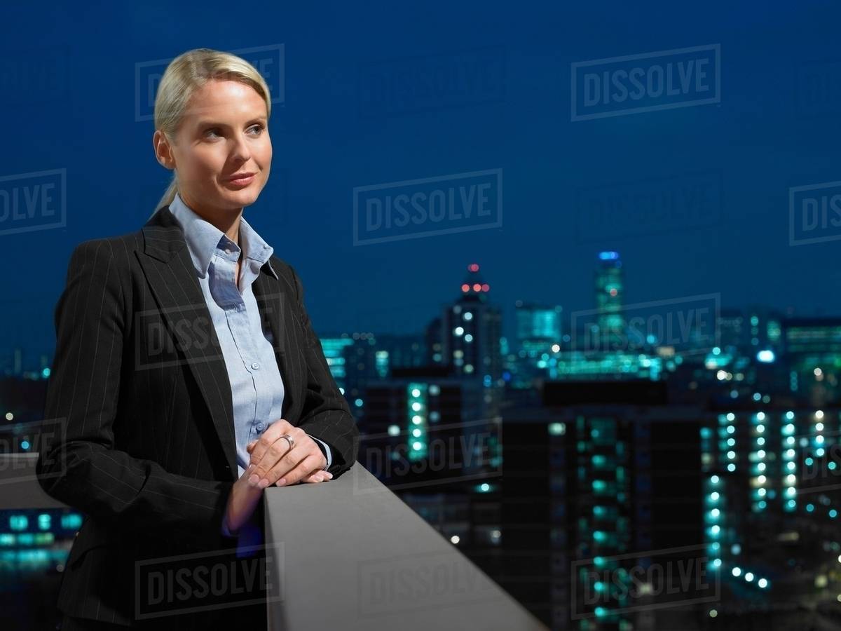 Smart lady in corporate environment overlooking the city - Royalty-free ...