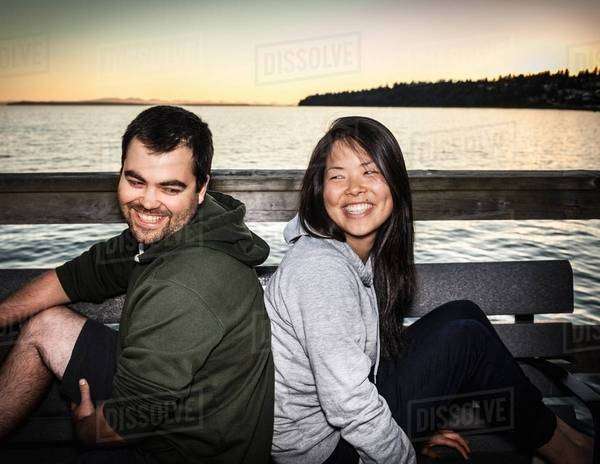 Couple smiling together outdoors - Stock Photo - Dissolve