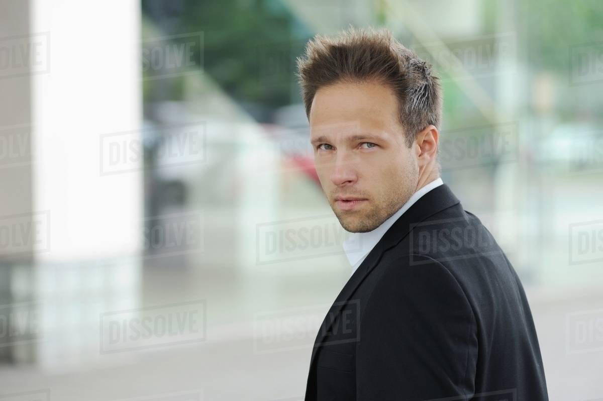 Businessman standing at window - Royalty-free Stock Photo | Dissolve