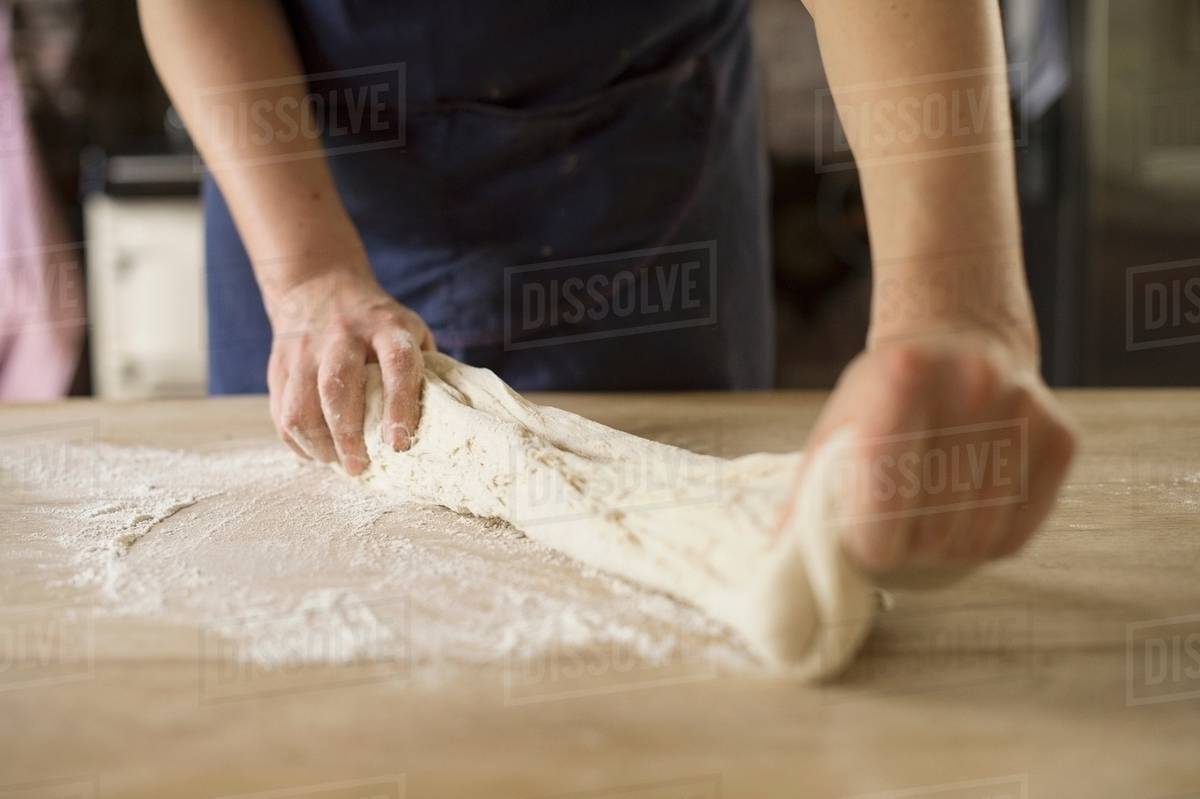 Close up of hands stretching bread dough - Royalty-free Stock Photo ...
