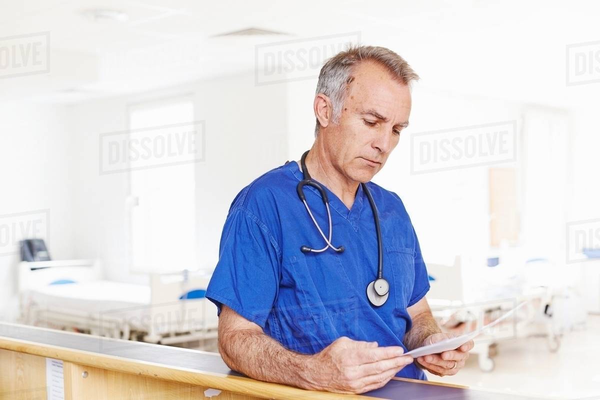 Doctor reading notes - Stock Photo - Dissolve