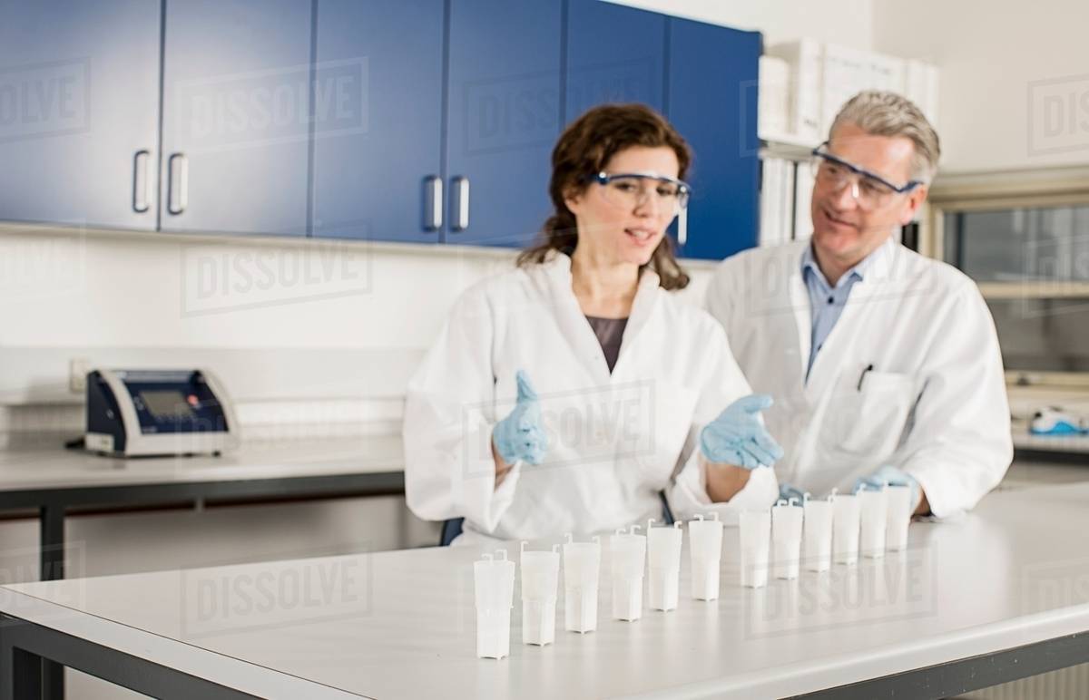 Two scientists in laboratory - Stock Photo - Dissolve