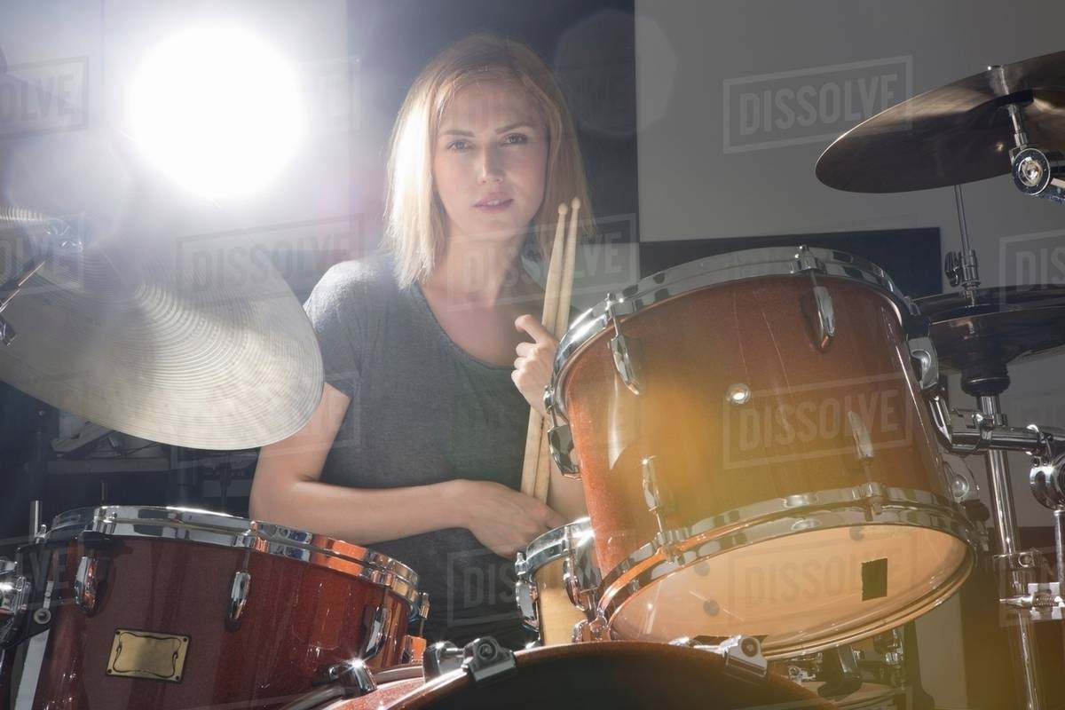 Female drummer sitting behind drums - Royalty-free Stock Photo | Dissolve
