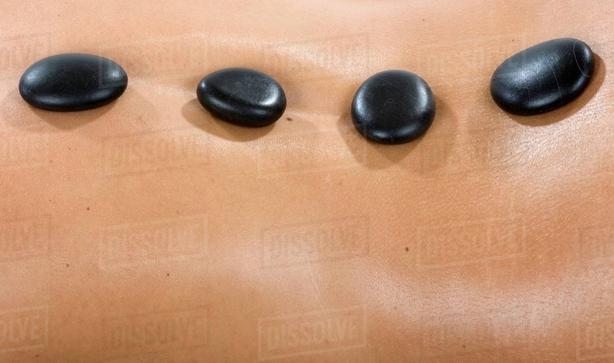 Hot stones on woman's back - Royalty-free Stock Photo | Dissolve
