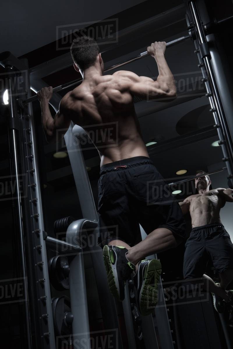 Man doing chin-ups - Royalty-free Stock Photo | Dissolve