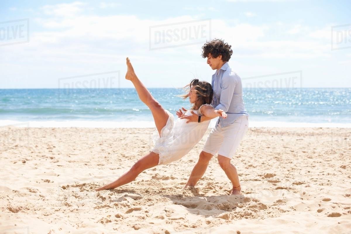 Couple tangoing on beach - Stock Photo - Dissolve