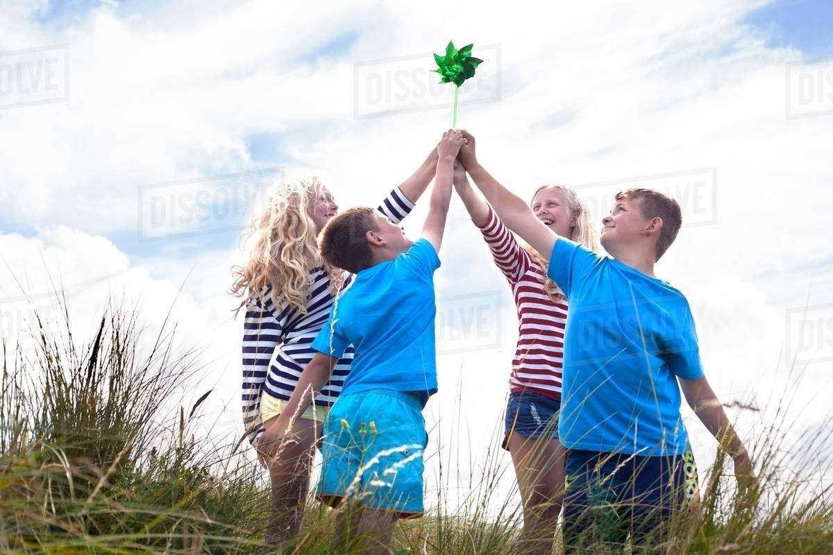 Four friends holding pinwheel, Wales, UK - Royalty-free Stock Photo ...