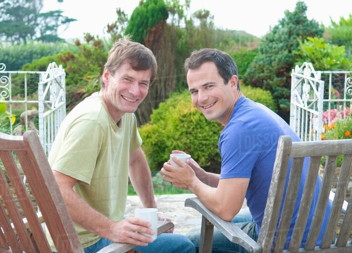 Two male adult friends relaxing in garden - Royalty-free Stock Photo ...
