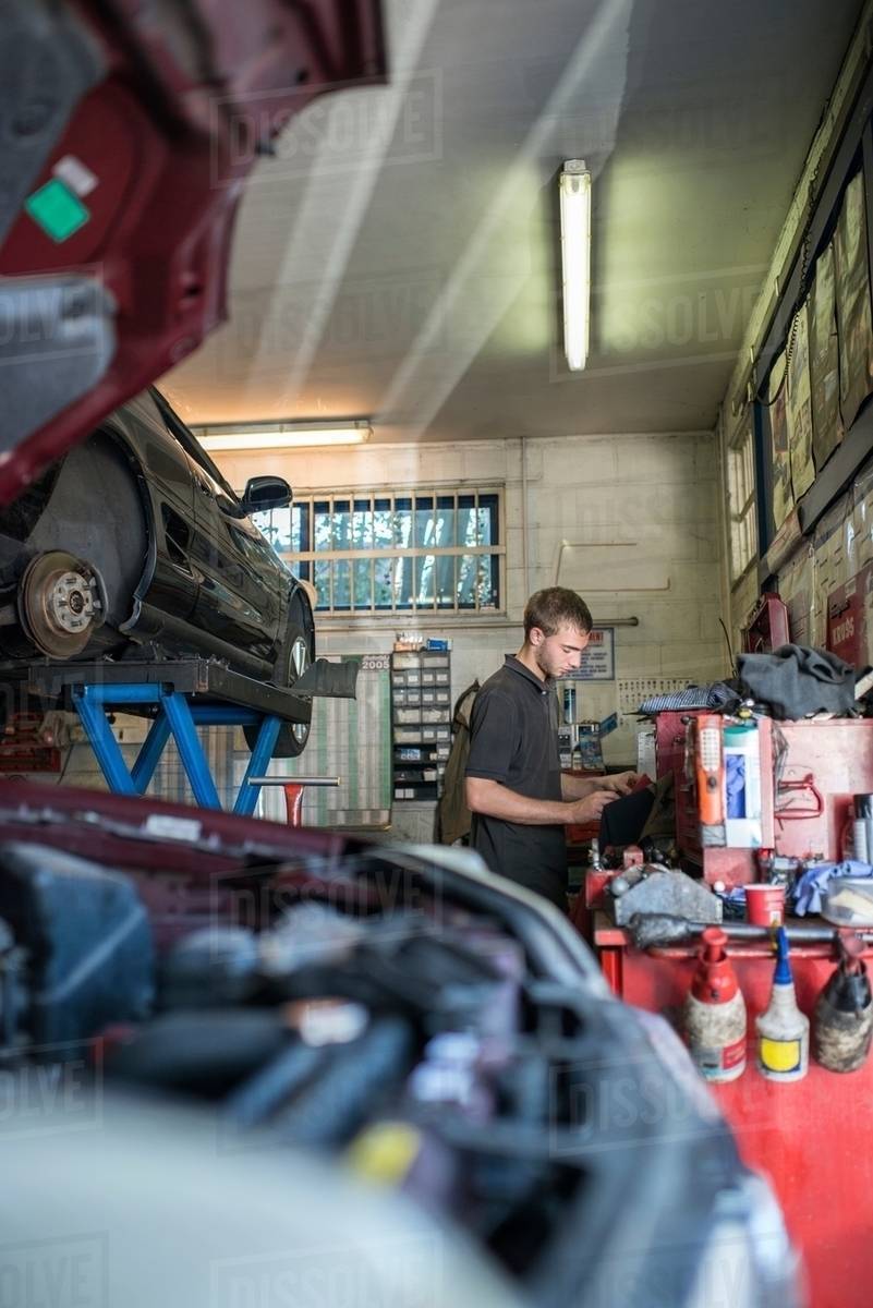 Mechanic working in garage - Royalty-free Stock Photo | Dissolve